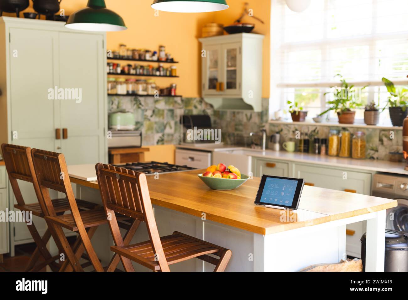 A modern kitchen interior features a tablet on the table Stock Photo ...