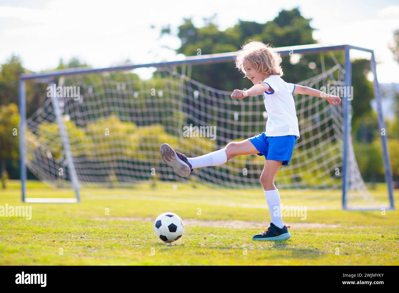 Kids play football on outdoor field. England team fan. Children score a ...