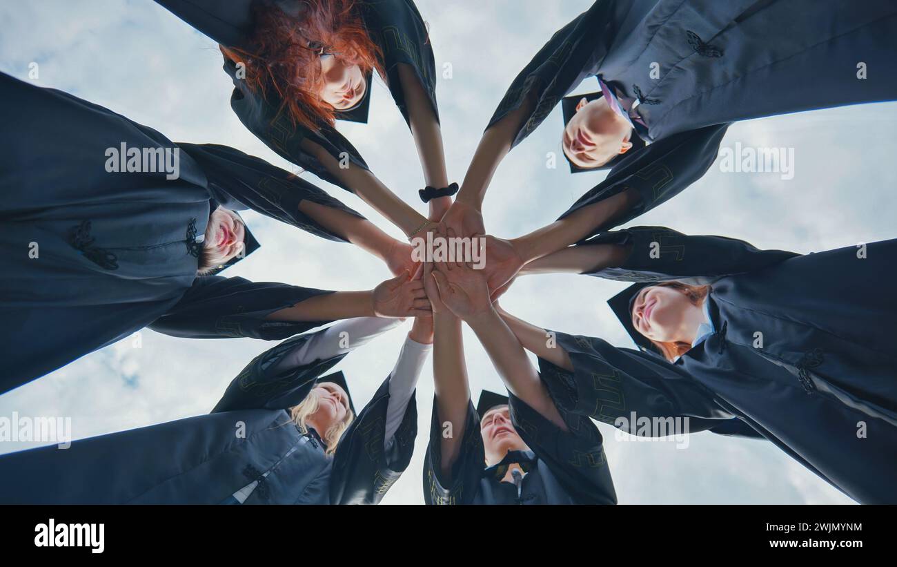 College students teamwork stacking hand hi-res stock photography and ...