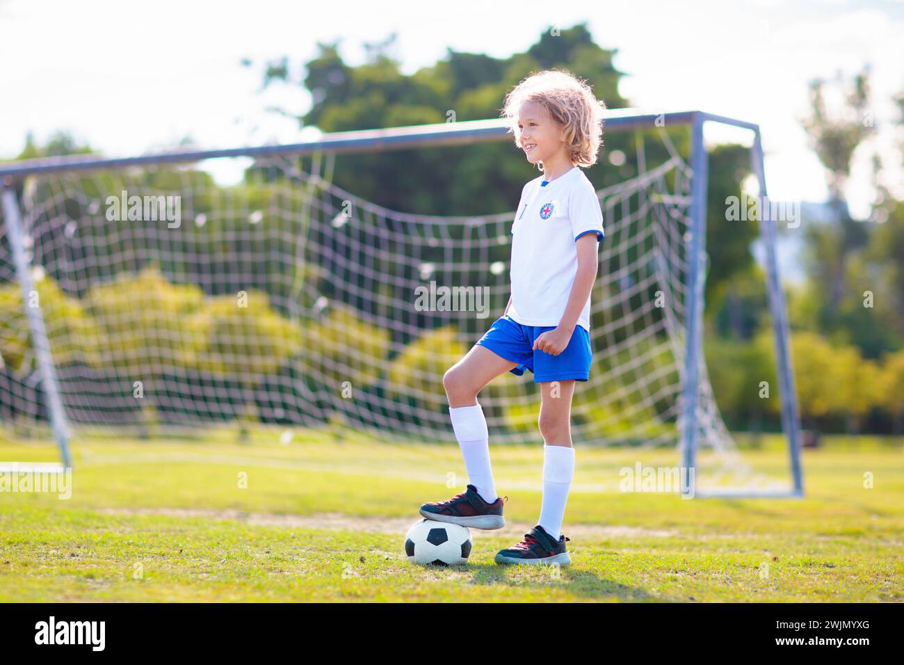 Kids play football on outdoor field. England team fan. Children score a ...