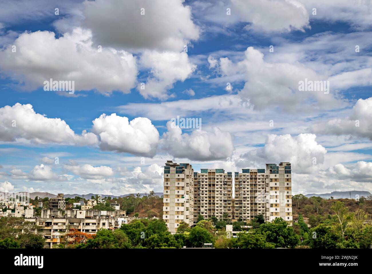 Tall residential buildings construction with nice clouds in blue sky ...
