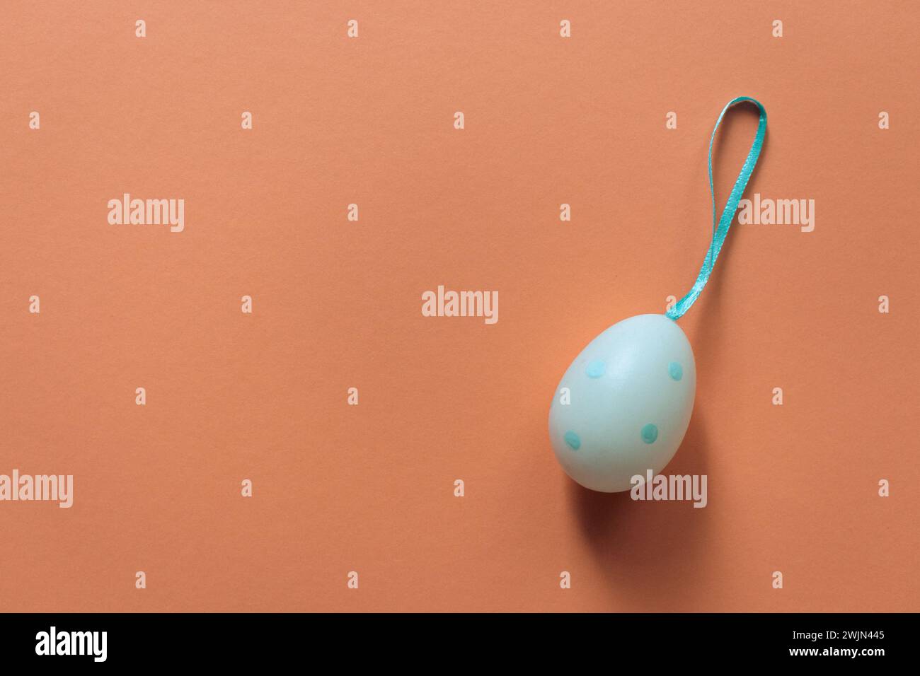 Easter egg on peach fuzz color background. Easter egg with copy space ...