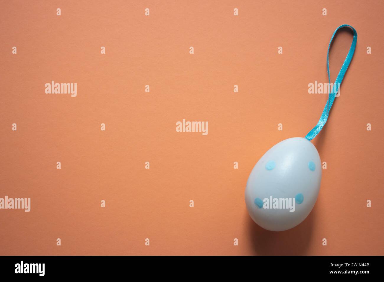 Easter egg on peach fuzz color background. Easter egg with copy space ...