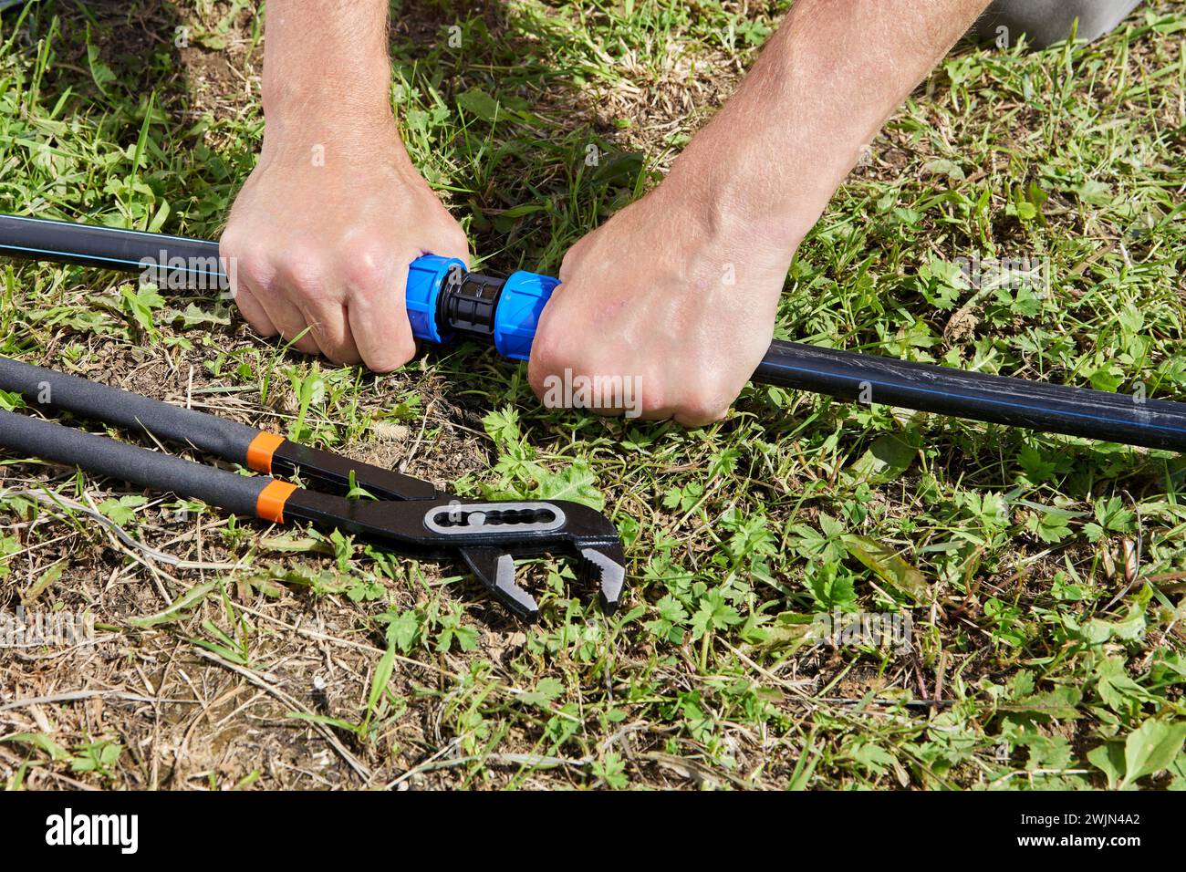 Parts of polyethylene pipe are connected by coupling fitting with a ...