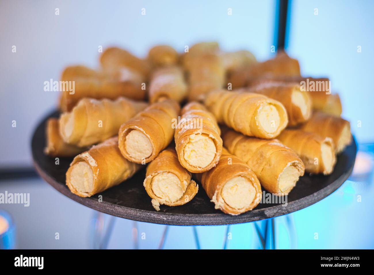Close-up of round dish with delicious tubes with cottage cheese ...