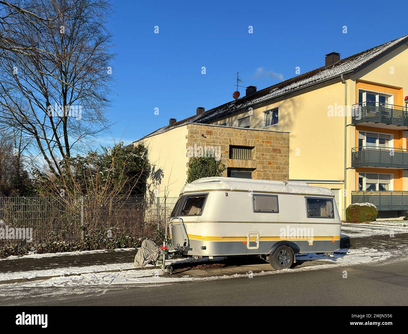Caravan is on the street in front of the house. Side view Stock Photo ...