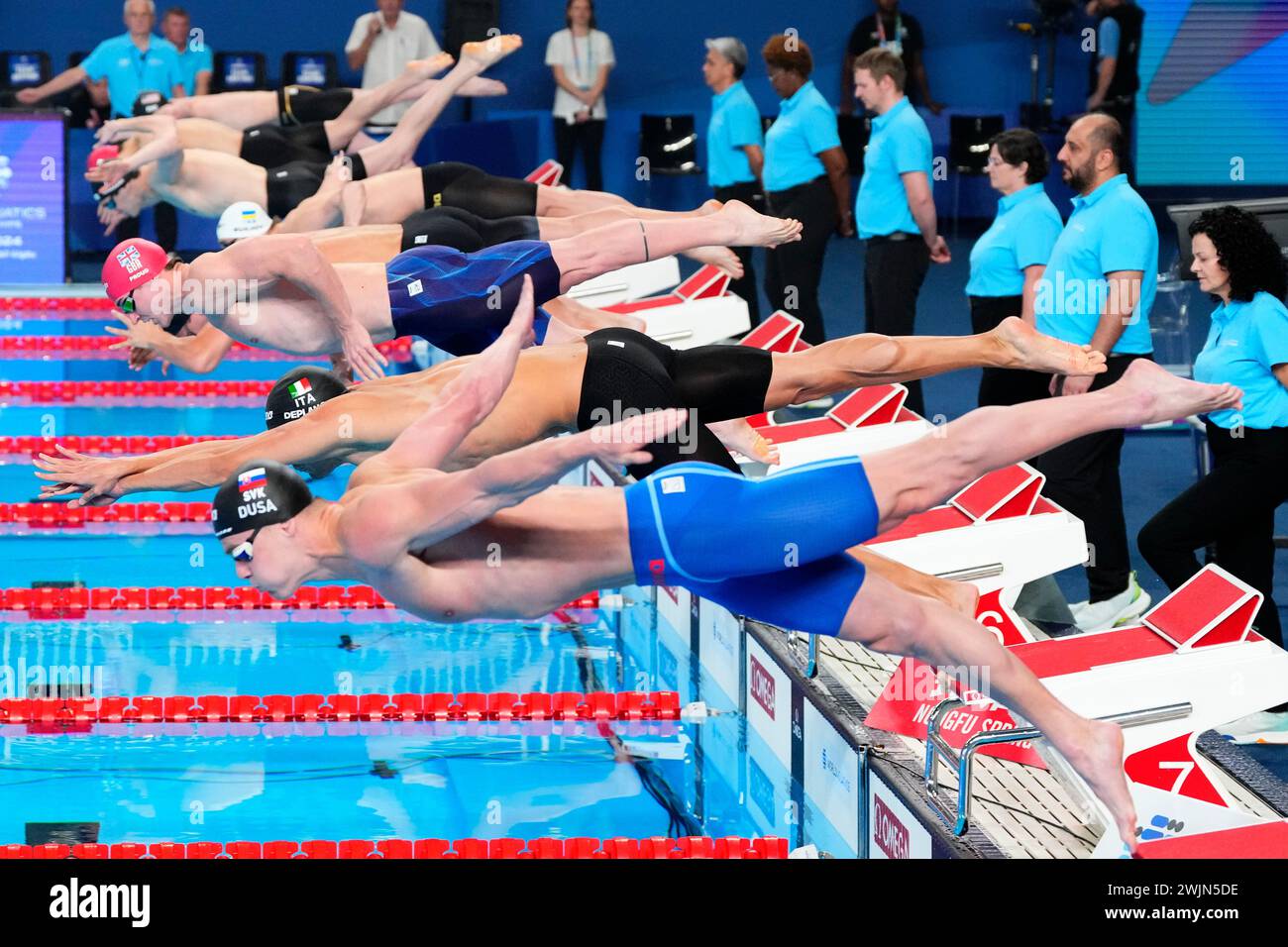 Swimers dive into the pool at the start of the men's 50m freestyle ...