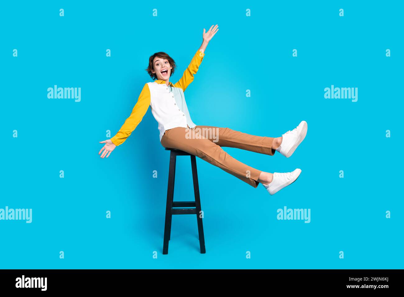 Photo Of Excited Carefree Girl Agent Sit Chair Raise Hands Feel Fun
