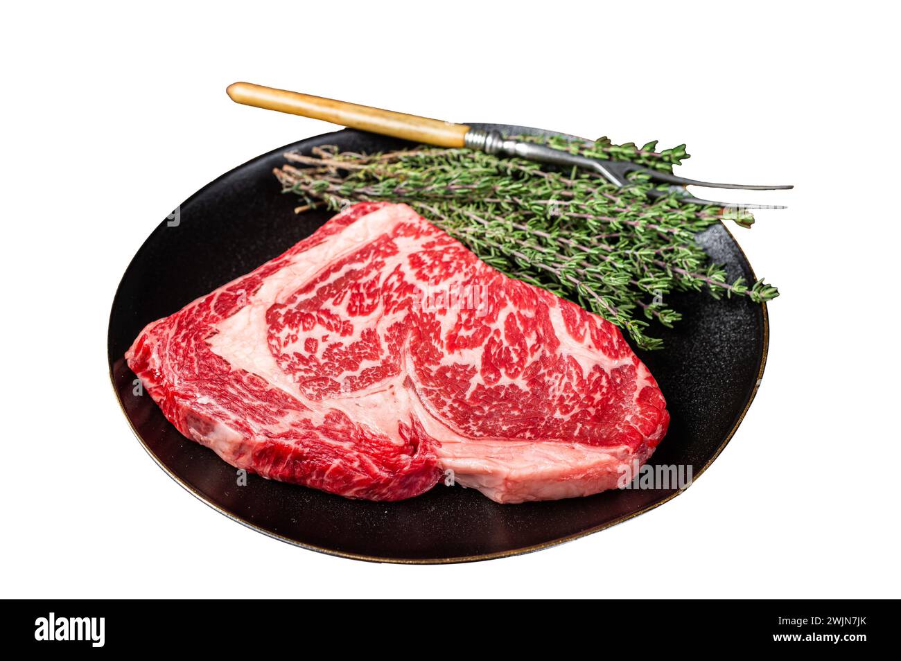 Black Angus Rib Eye steak, raw marbled beef meat with herbs. Isolated ...
