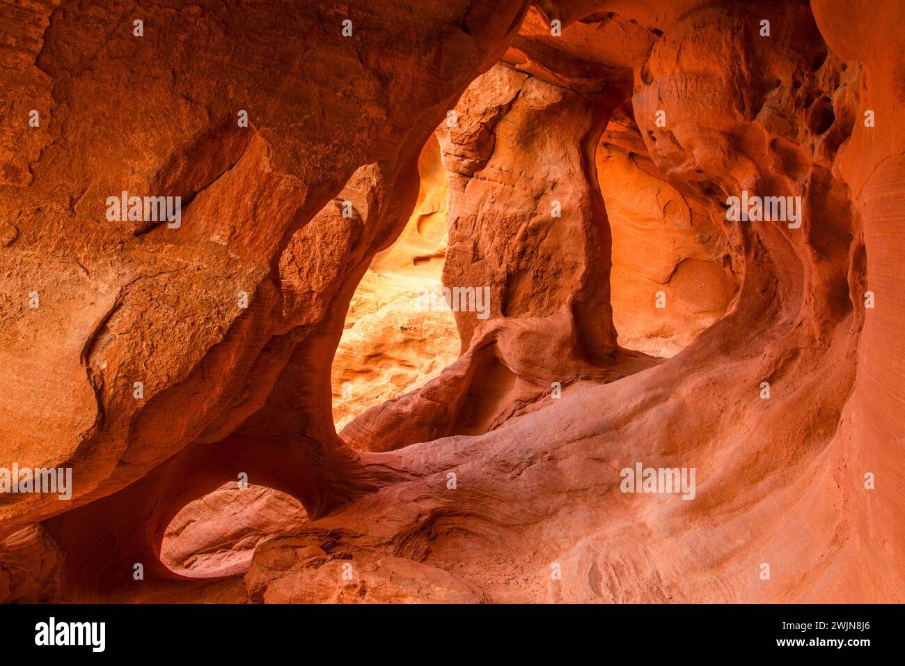 Three small arches in the colorful eroded Aztec sandstone of the Fire ...