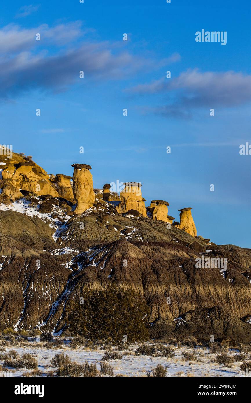Sandstone hoodoos standing on badlands shale in winter in northwest New ...