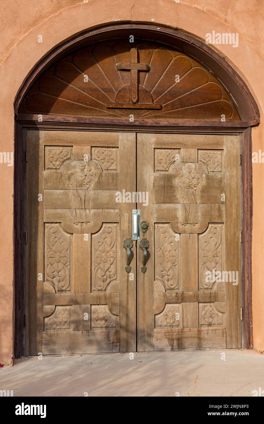 Carved wooden doors of the old mission-style Catholic parish church in ...