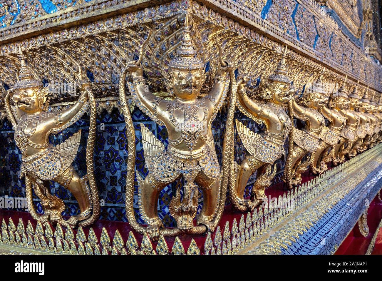 Line of Garuda statues adorning a temple wall in the Grand Palace ...