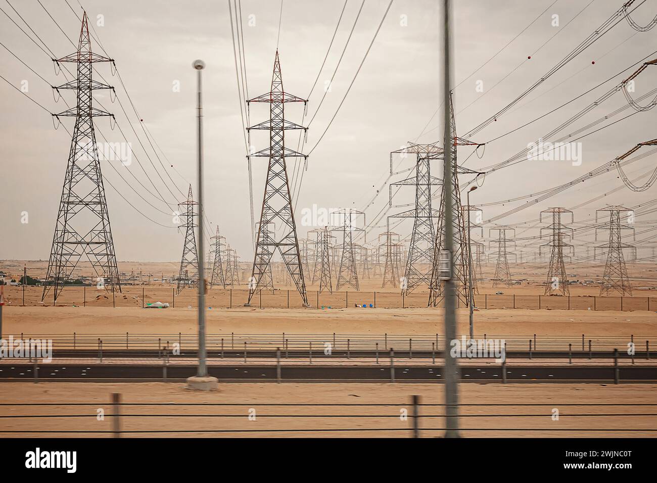 a series of electrical pylons in the kuwait desert Stock Photo - Alamy