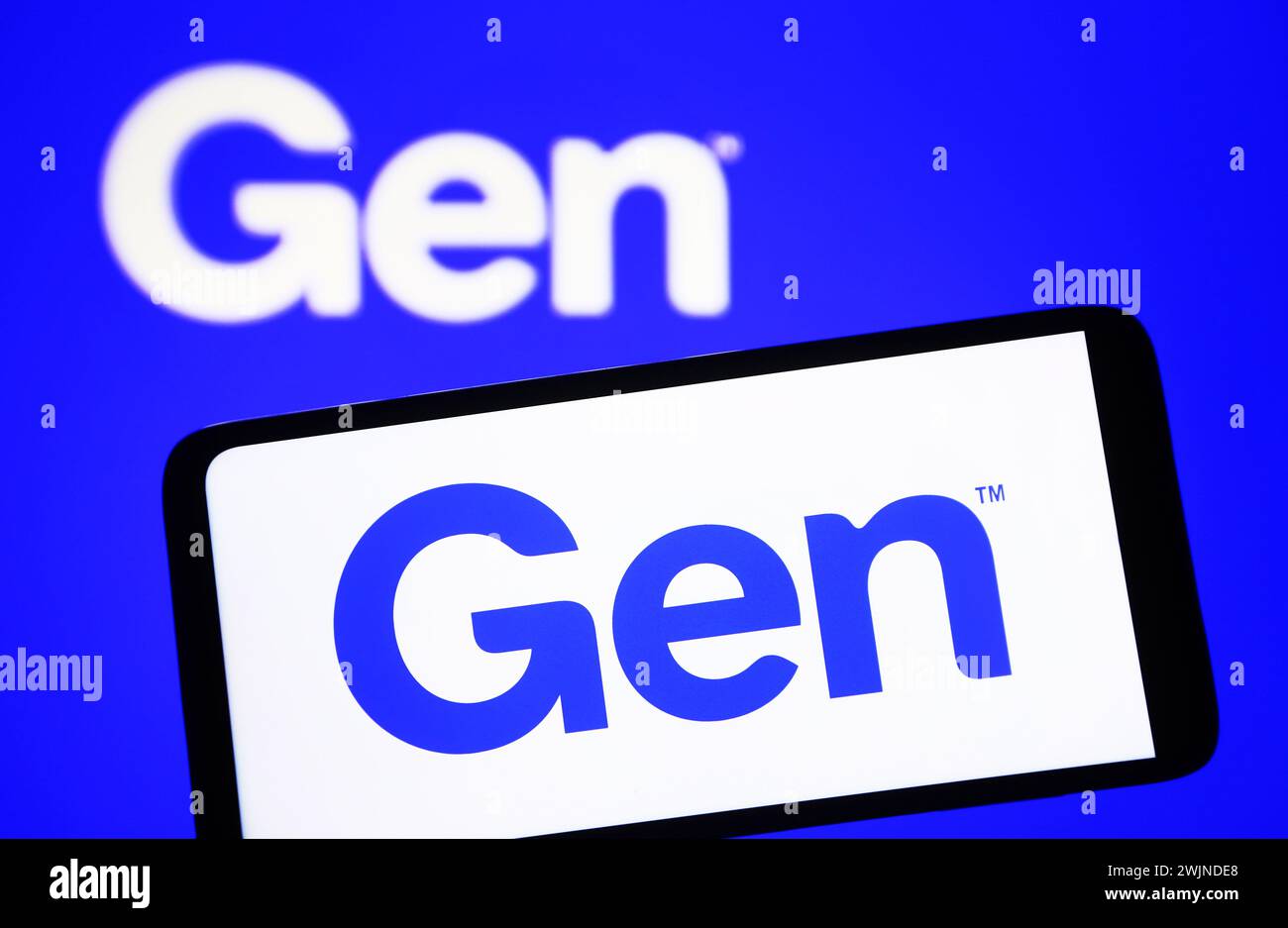 In this photo illustration, the Gen Digital Inc. logo is seen on a smartphone and in the ...