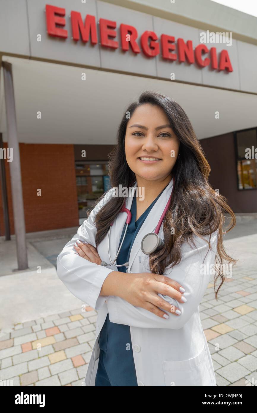 hospital exterior at emergency service entrance a young female doctor ...