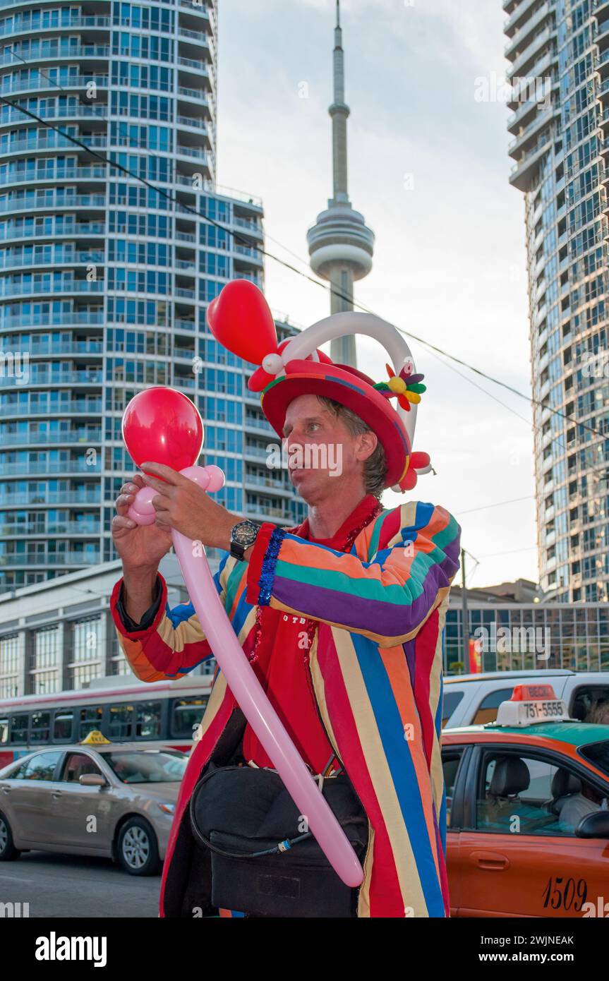 Street artists inflating animal balloons in downtown district, Toronto ...