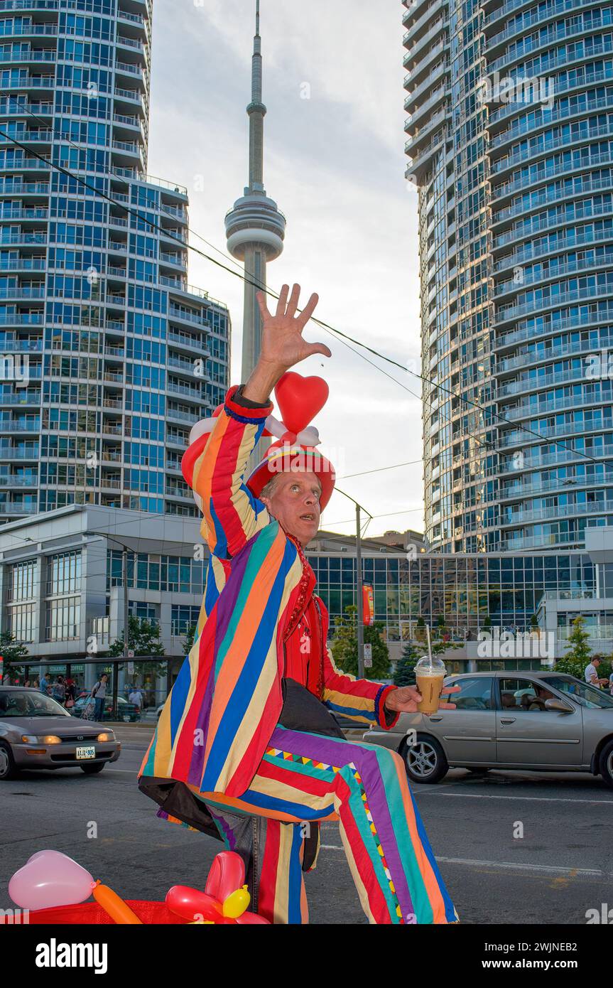 Street artists inflating animal balloons in downtown district, Toronto ...