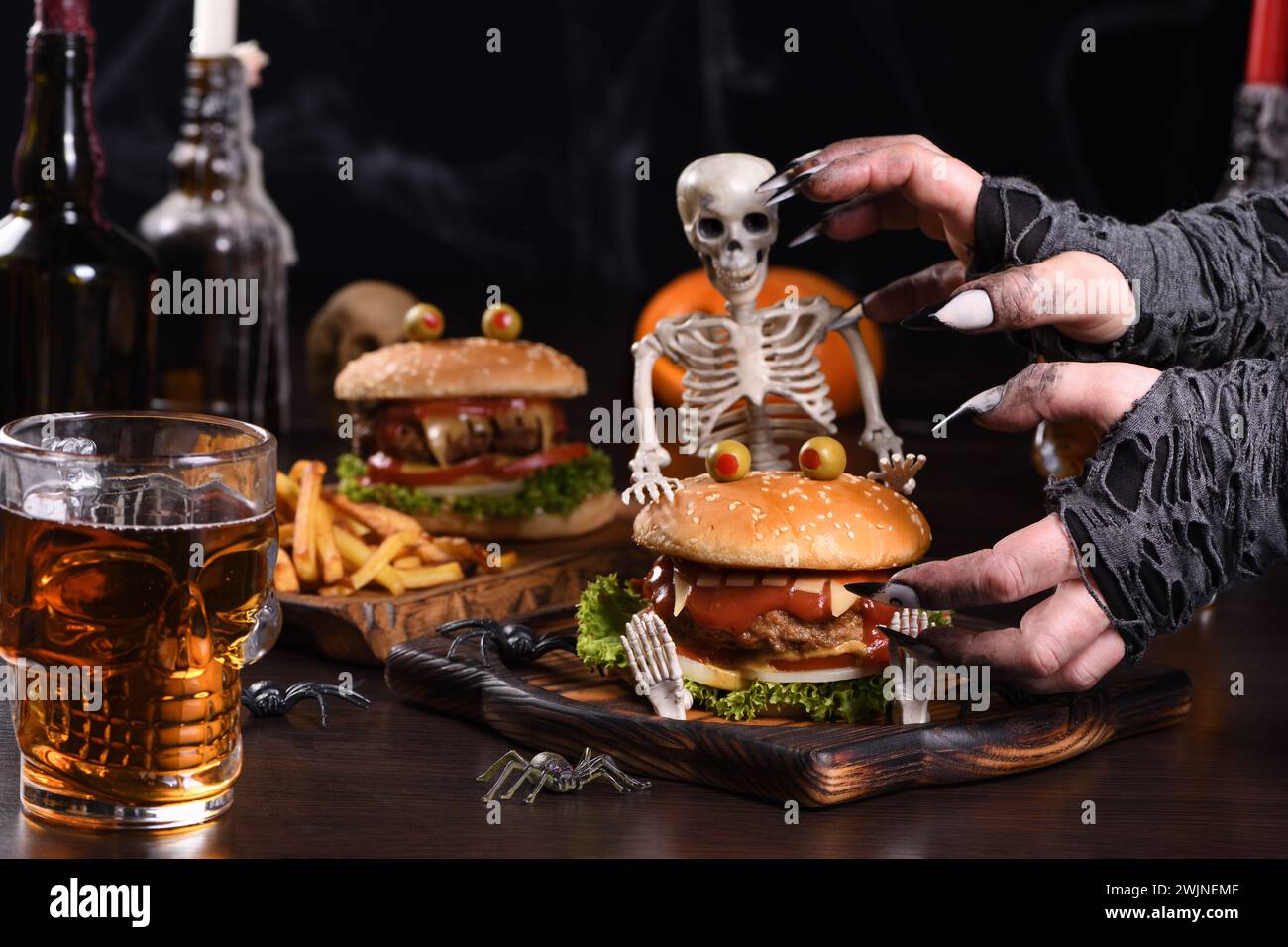 The witches hands want to grab the Monster Burger on the sitting ...