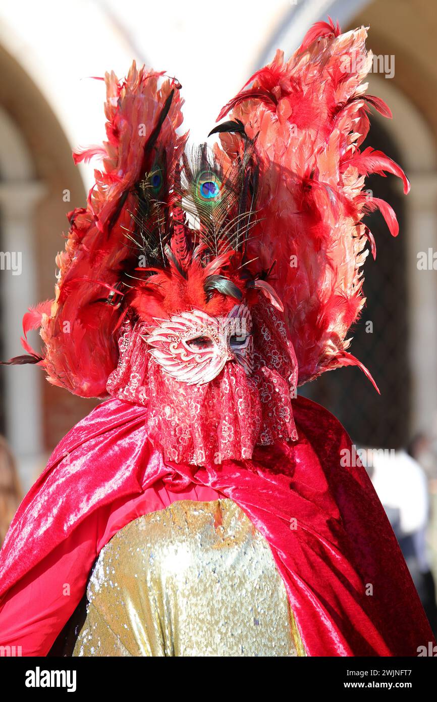 Venice, VE, Italy - February 13, 2024: Venetian mask in gold and red ...