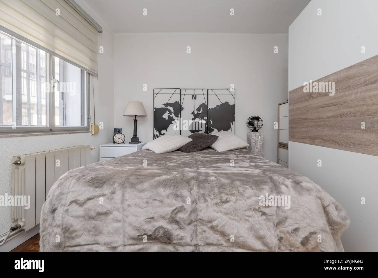 Bedroom with a large bed filling the entire space and a closet with ...