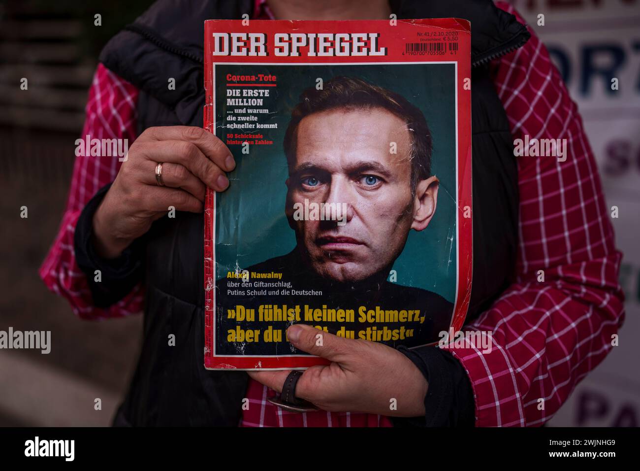 A woman holds a magazine with a portrait of Russian opposition leader ...