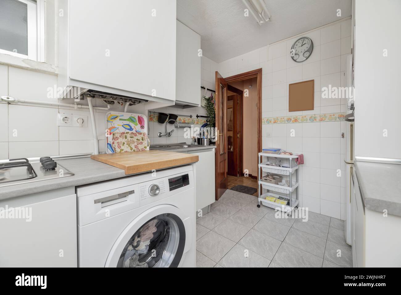 Image of a small kitchen with white furniture, integrated appliances ...