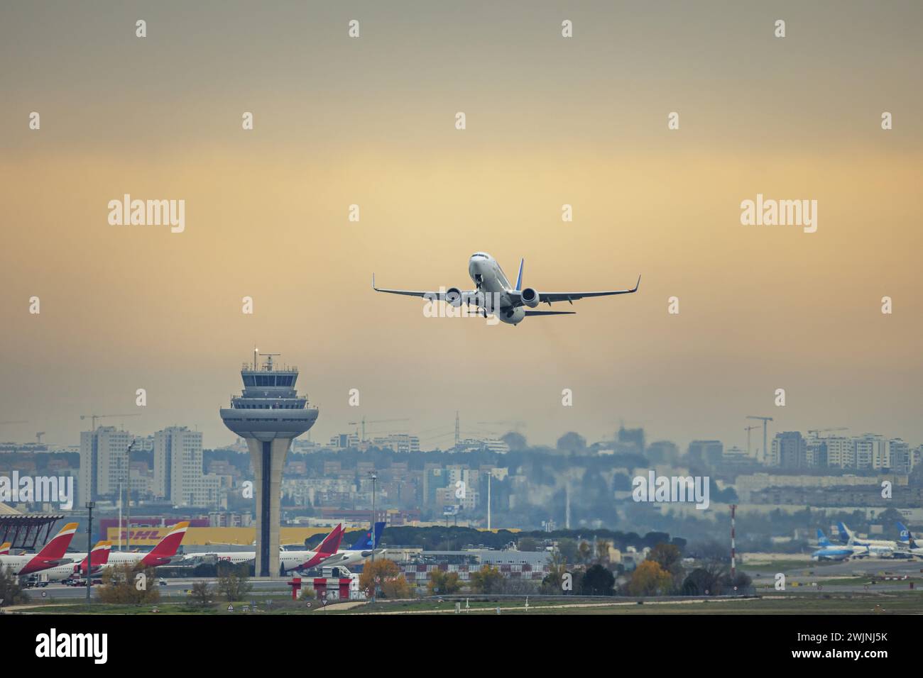 A plane taking off from a runway with the city in the distance Stock ...