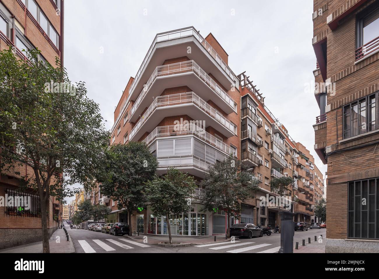 Facades of urban housing on the corner of a street intersection with ...