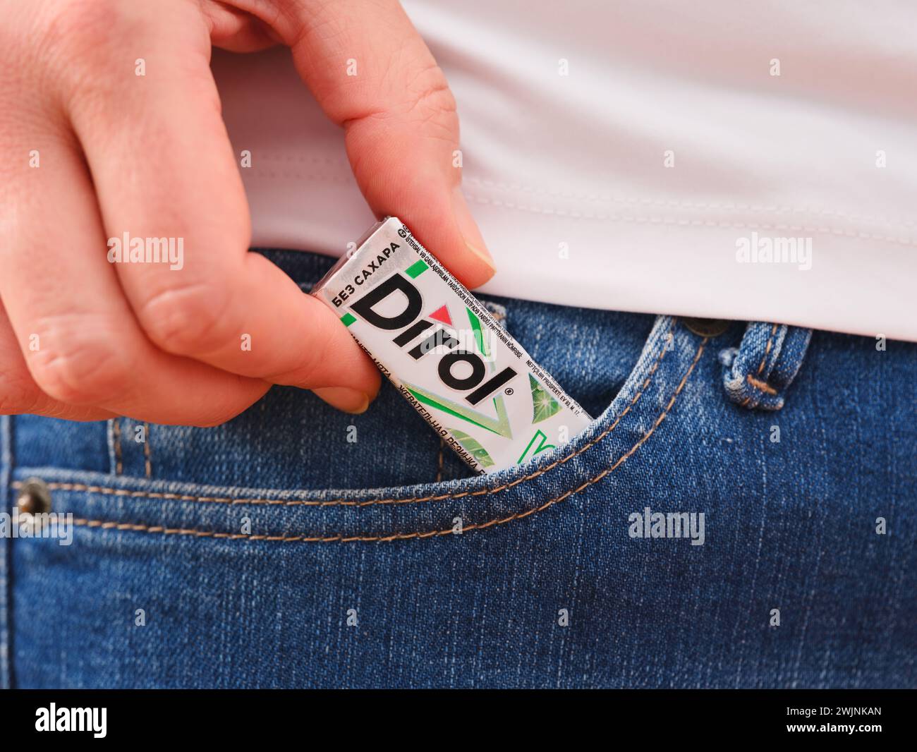 Tambov, Russian Federation - December 20, 2023 A woman taking a pack of ...