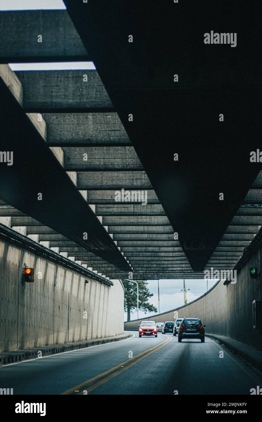 The Cars driving on in a tunnyl under bridge with roof trusses Stock ...