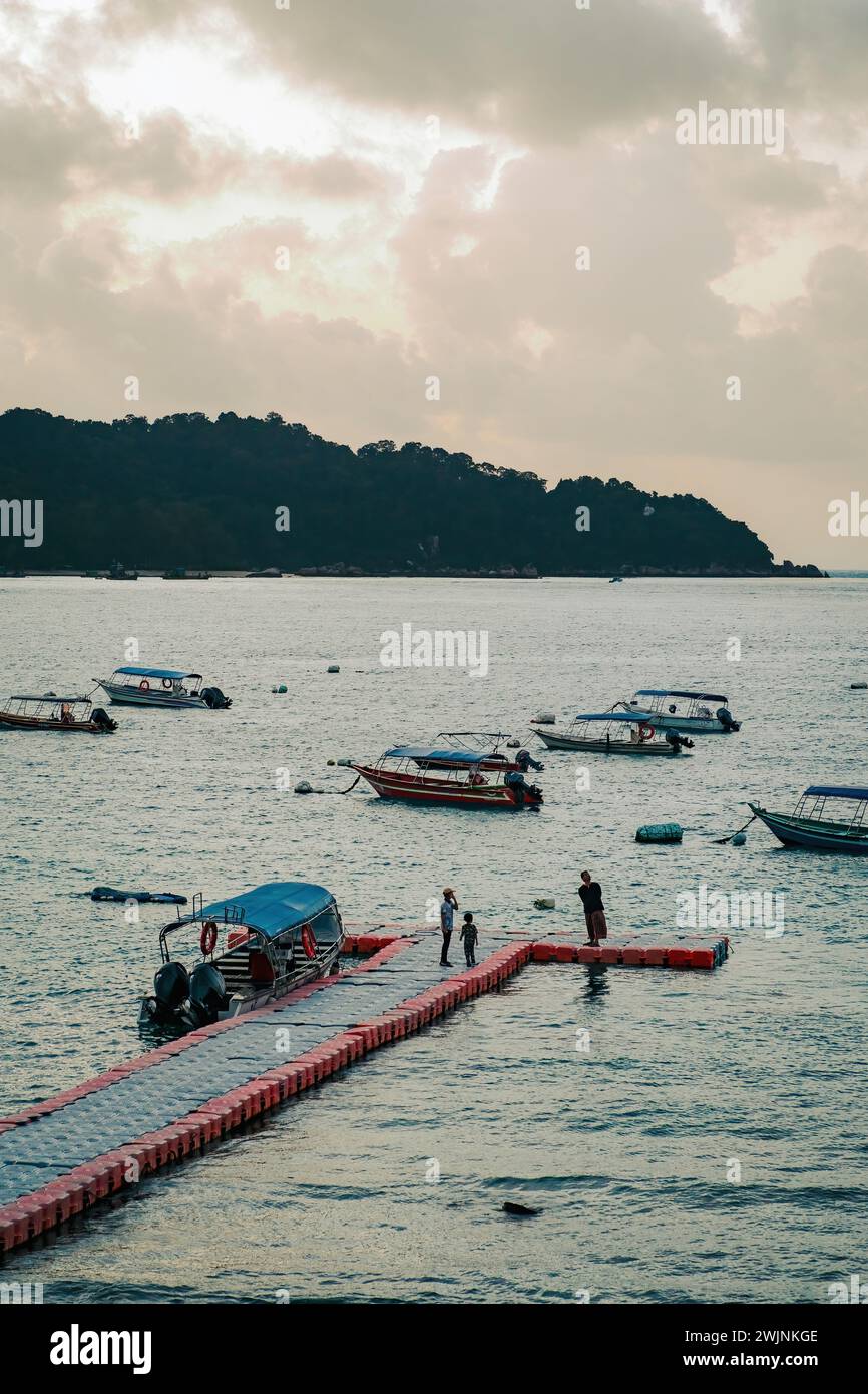 The colorful boats near the floating jetty on Perhentian Island in the ...