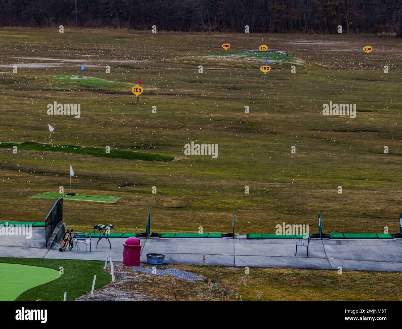 An aerial view of an empty golf driving range with dry grass on a ...