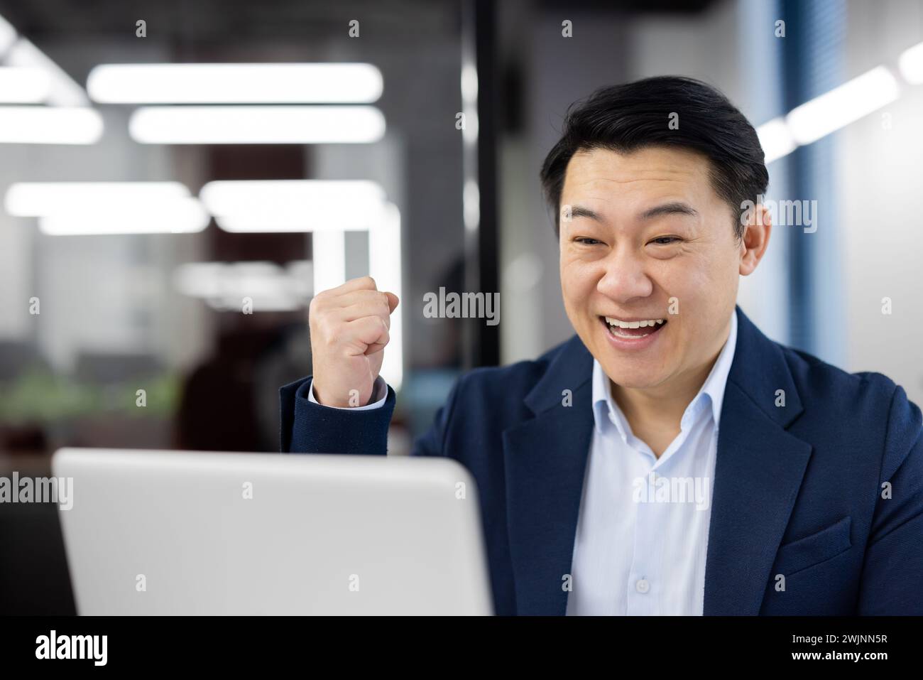 Asian man celebrating victory success, businessman in business suit ...