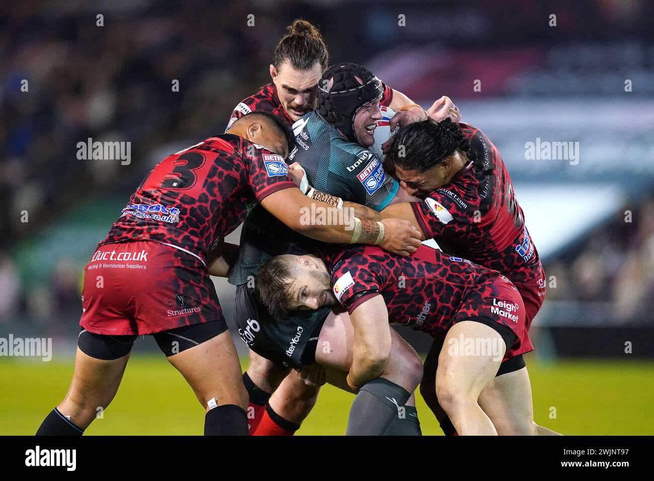 Huddersfield Giants' Chris Hill (centre) is tackled by Leigh Leopards ...