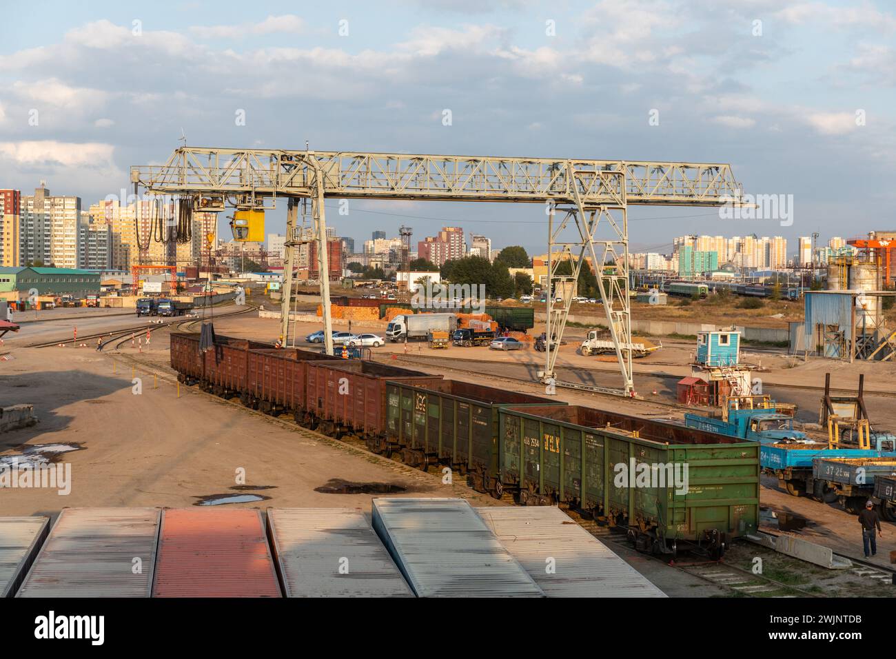 An old loading station with rusty wagons, containers and a steel ...
