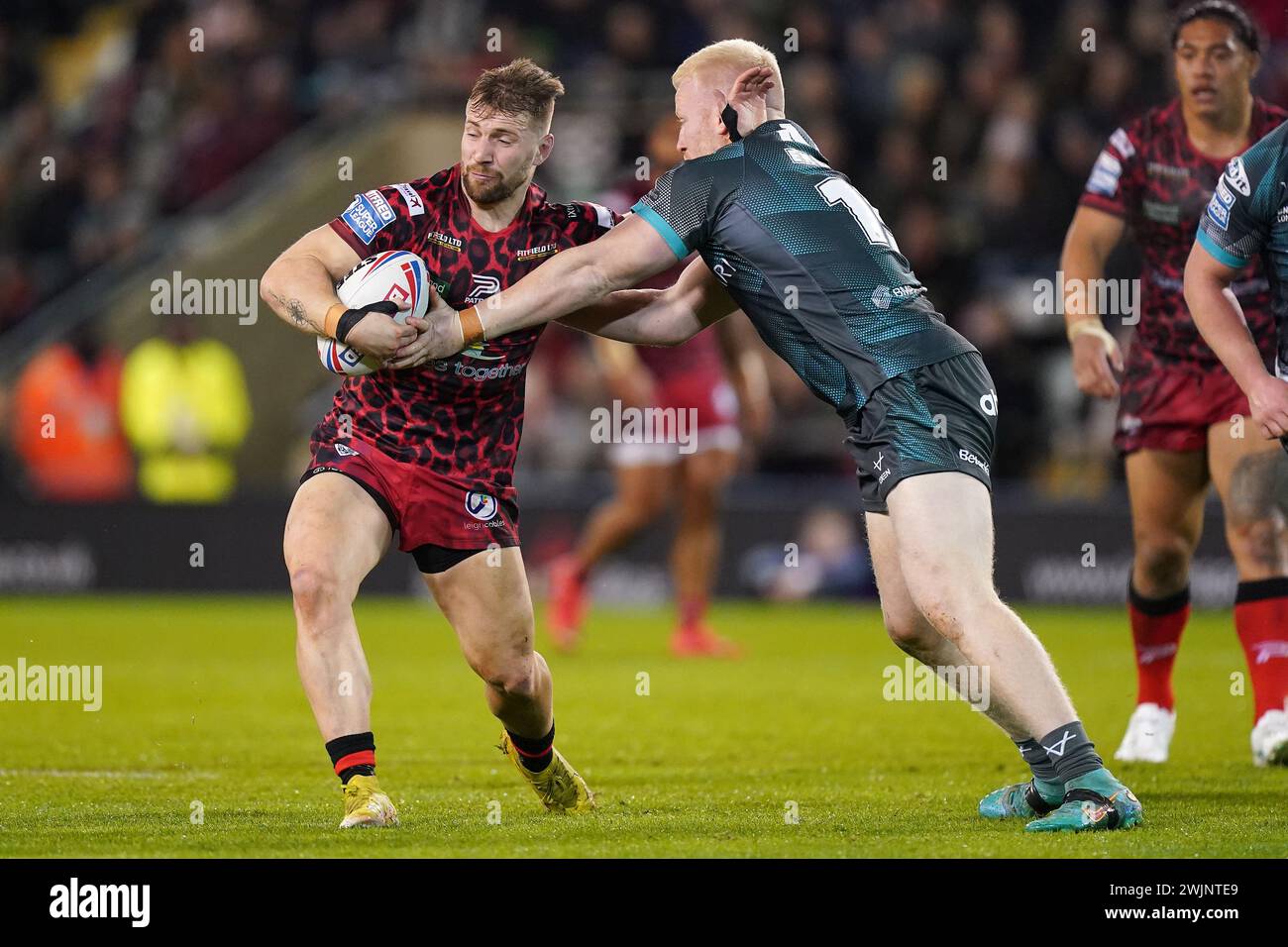 Leigh Leopards' Matt Davis (left) is tackled by Huddersfield Giants ...