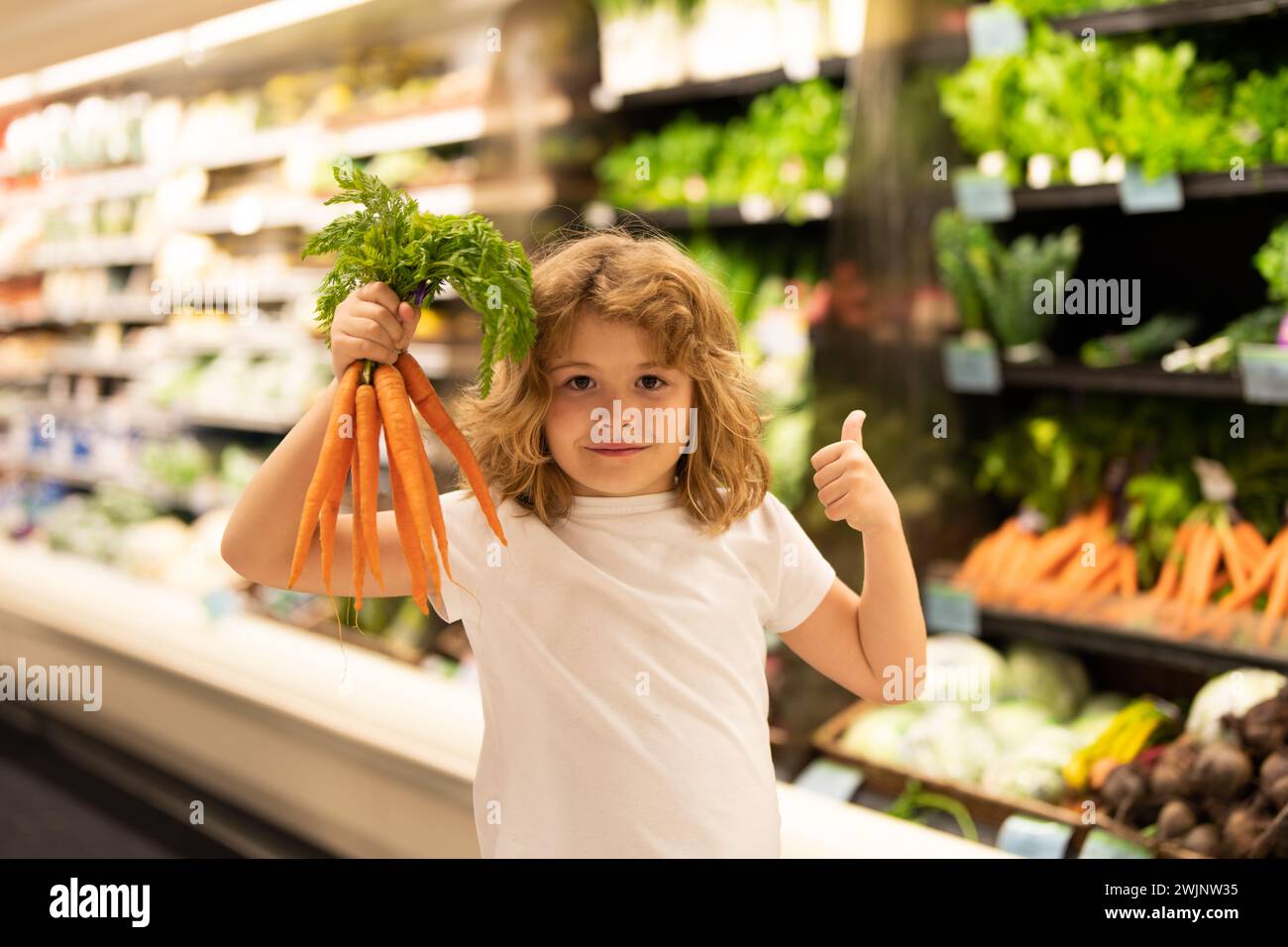 Child choosing vegetables in supermarket store. Kids in food ...