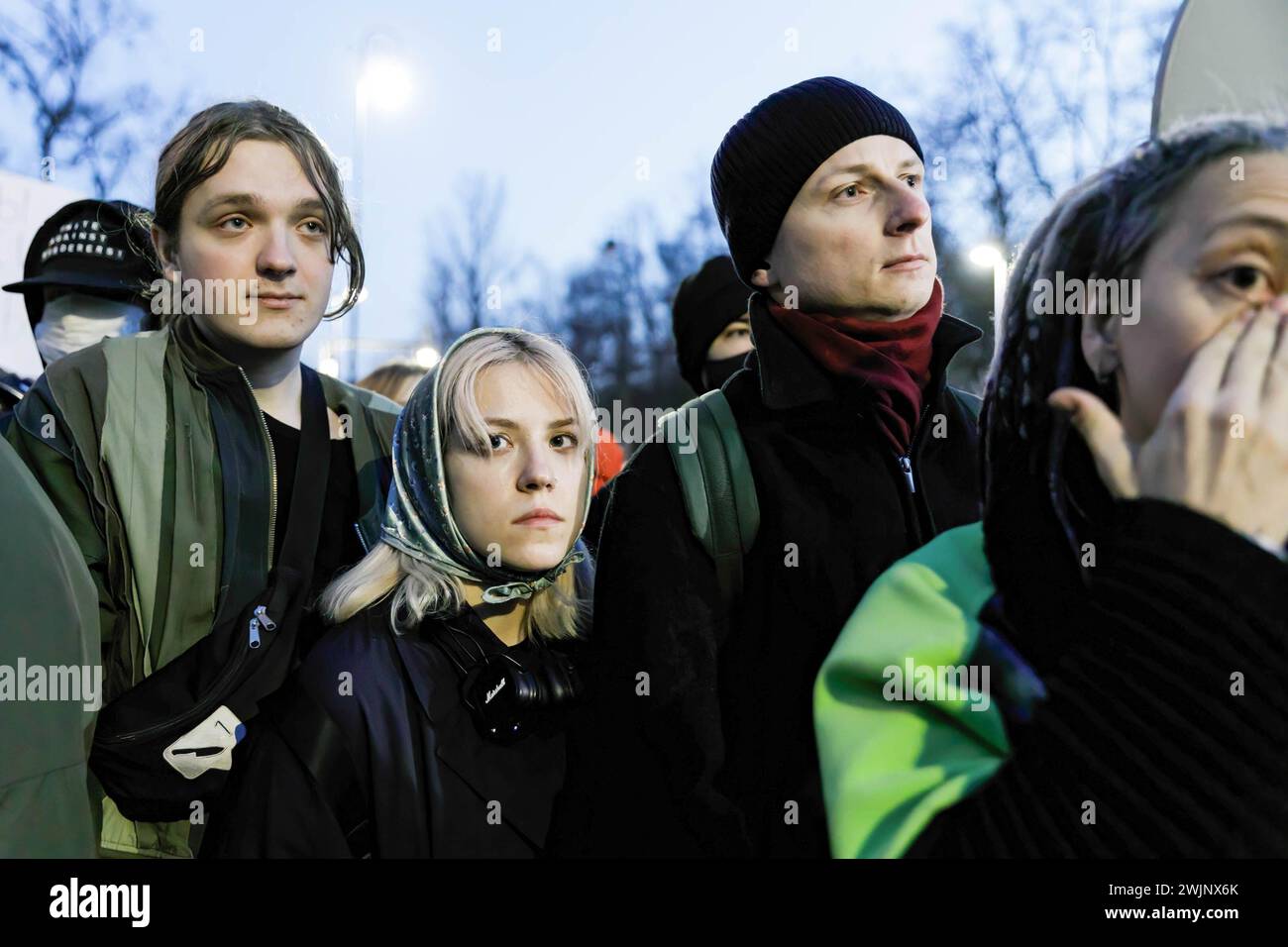 Protesters listen to the speeches of activists during a rally outside ...