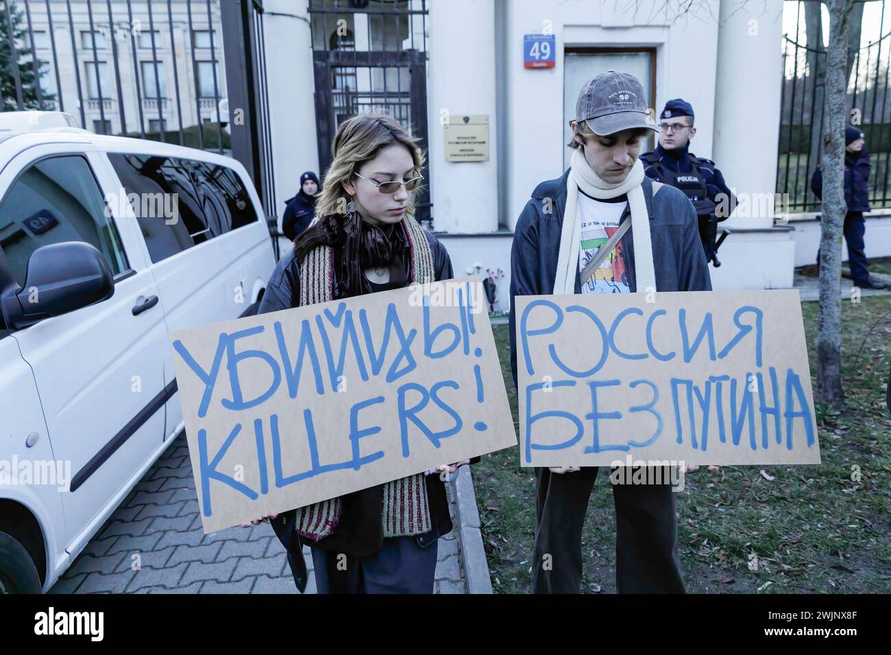 Protesters hold placards during a rally near the building of the ...