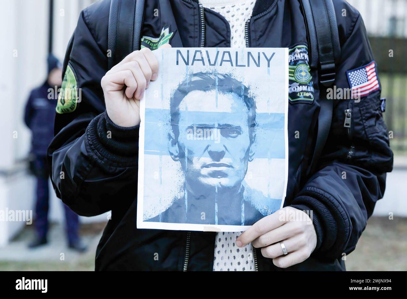 A man holds a portrait of Alexei Navalny during a rally near the ...