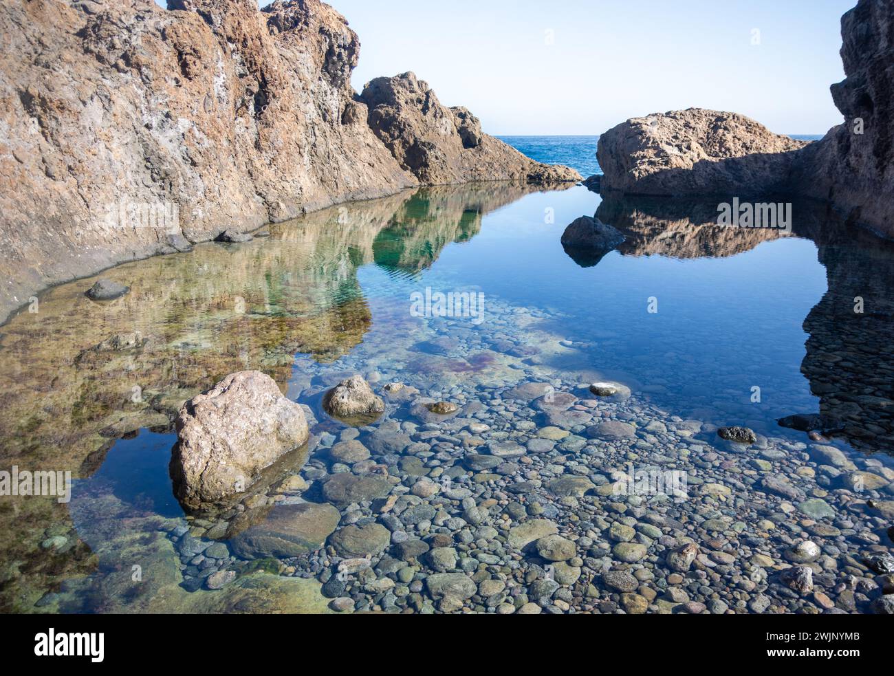 Natural pool of volcanic rocks in Tenerife submerged in the water Stock ...