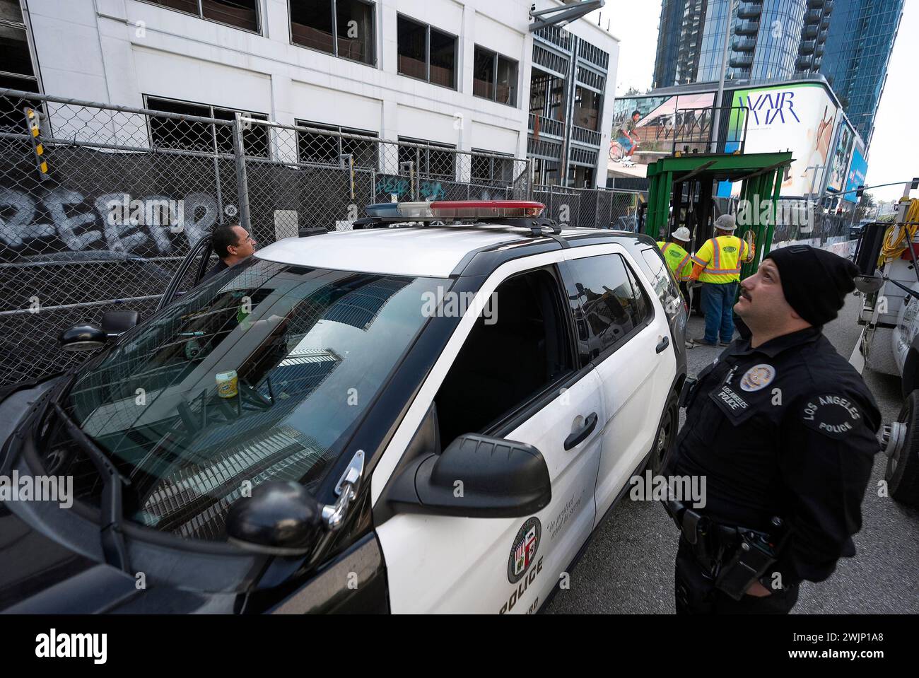 Los Angeles Police officers guard the exterior of an unfinished complex ...