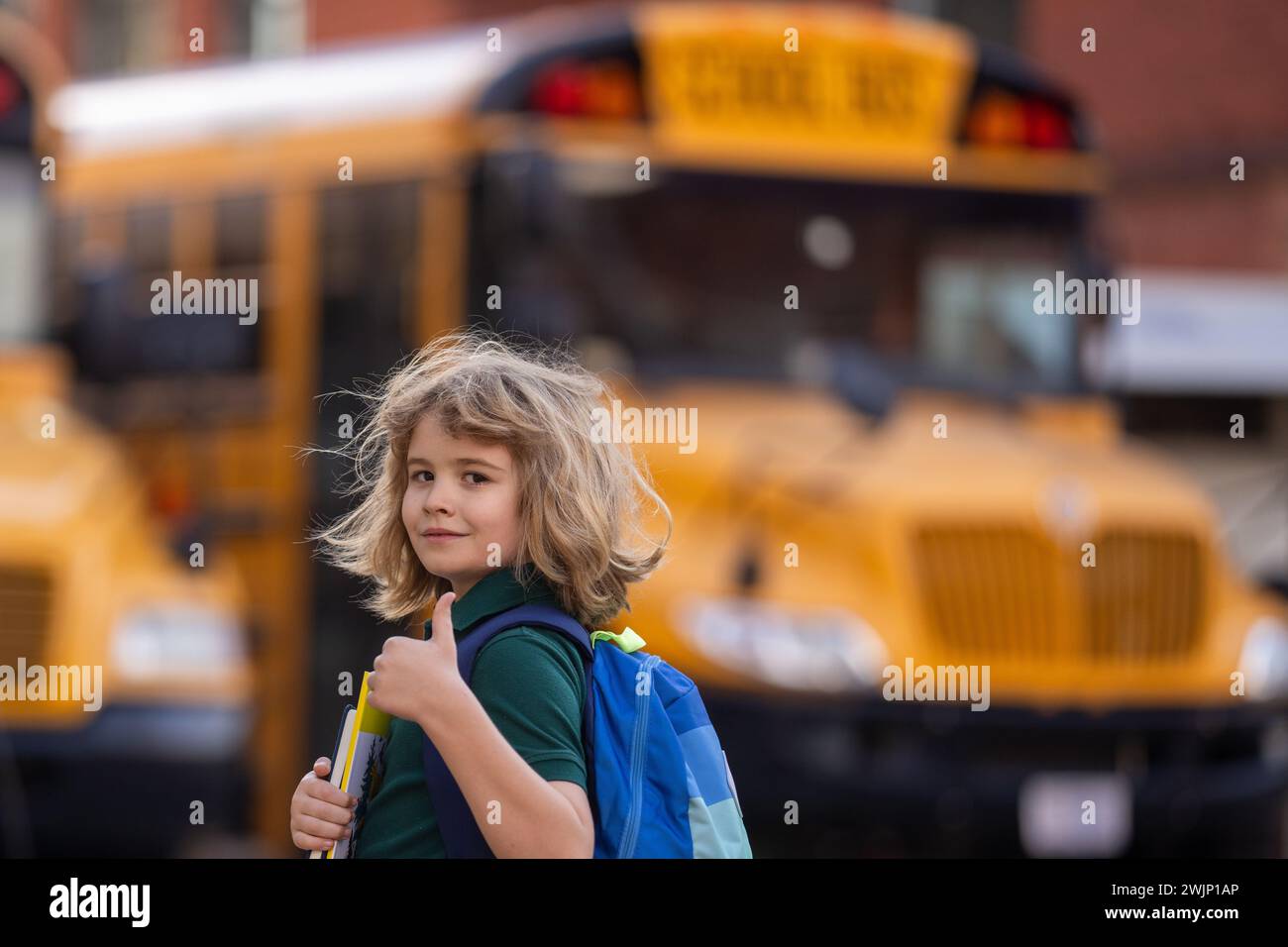 Schoolkid getting on the school bus. American School. Back to school ...