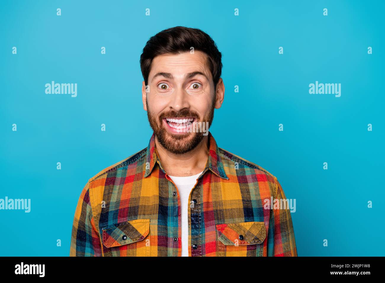 Portrait of impressed eccentric guy with stubble wear checkered shirt ...