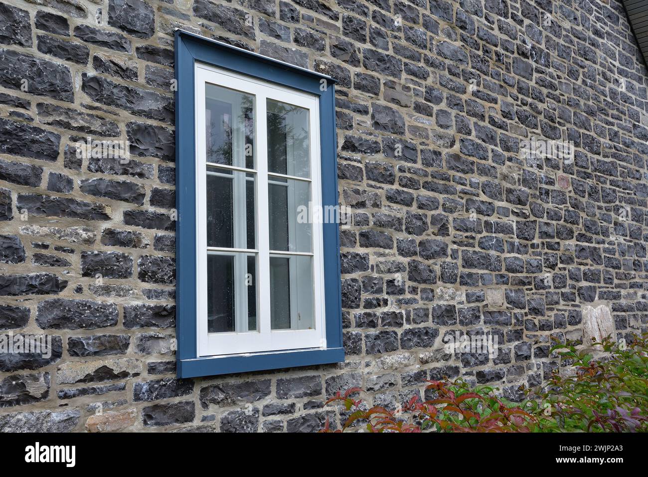 Blue and white window on a natural stone wall Stock Photo - Alamy