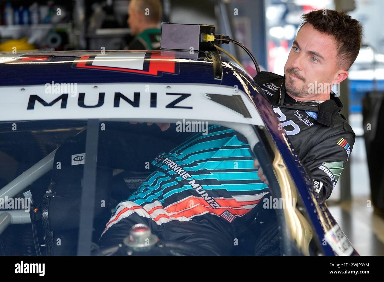 Race car driver and actor Frankie Muniz climbs into his car before a ...