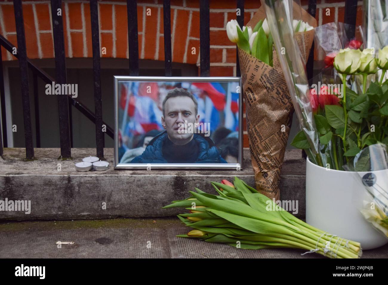 London, UK. 16th Feb, 2024. Flowers and a picture of Alexei Navalny are ...