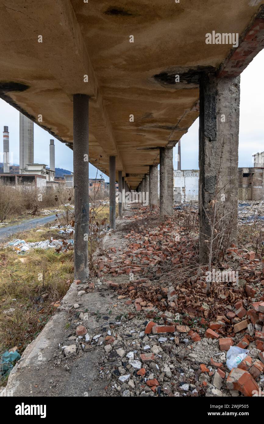 Corridor of an old chemical factory looted dilapidated crumbling bricks ...