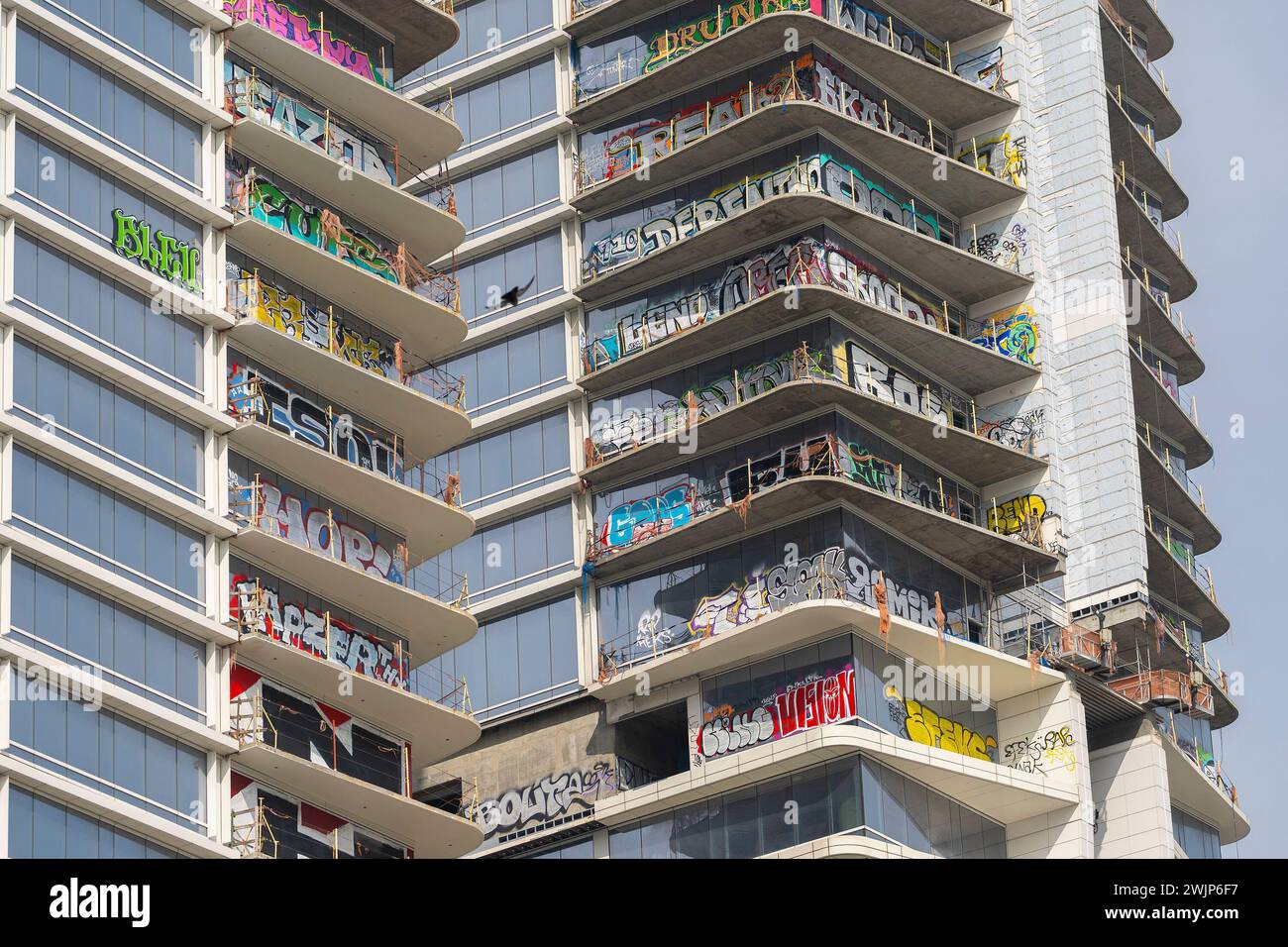 Windows are tagged with graffiti as seen on the balconies of an ...